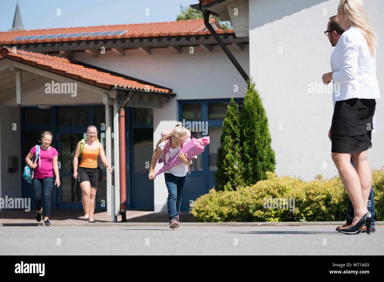 Little girl getting out of school after her first day Stock Photo - Alamy
