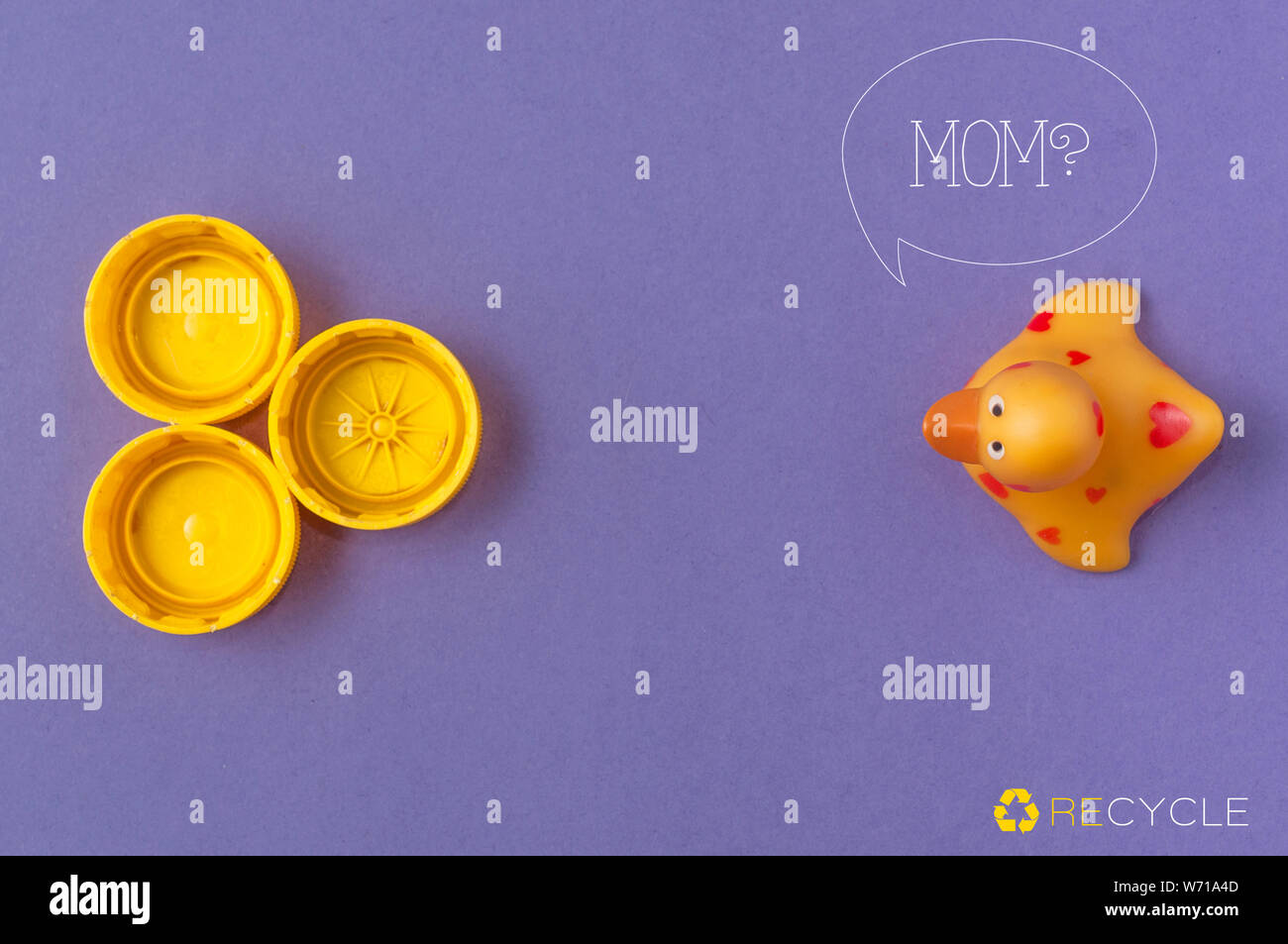 Recycling concept: a plastic yellow duck in front of three plastic ...