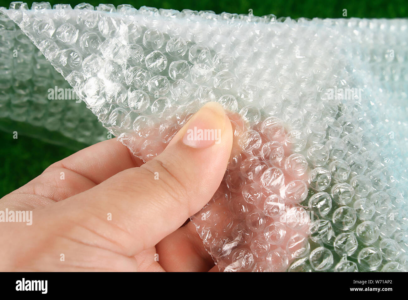 The hand touches the bubble wrap. The concept of touch, tactility ...