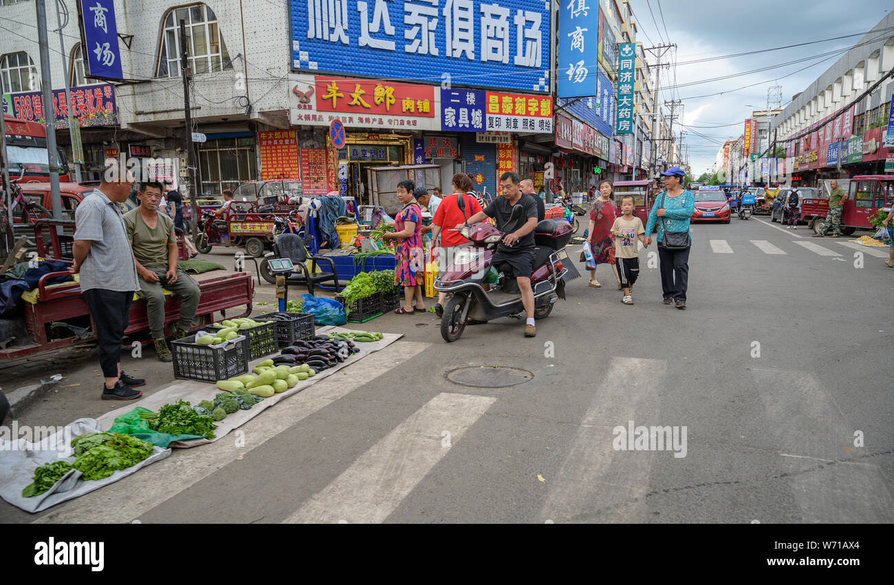 MISHAN, CHINA - JULY 27, 2019: People in commercial shopping street in ...