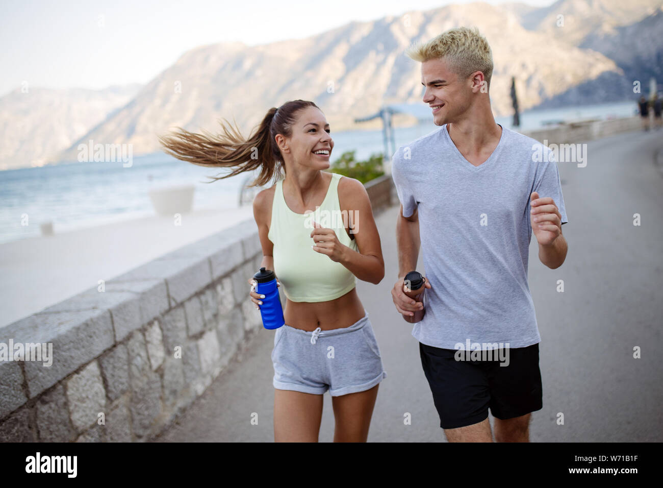 Group of young people friends running outdoors at seaside Stock Photo ...
