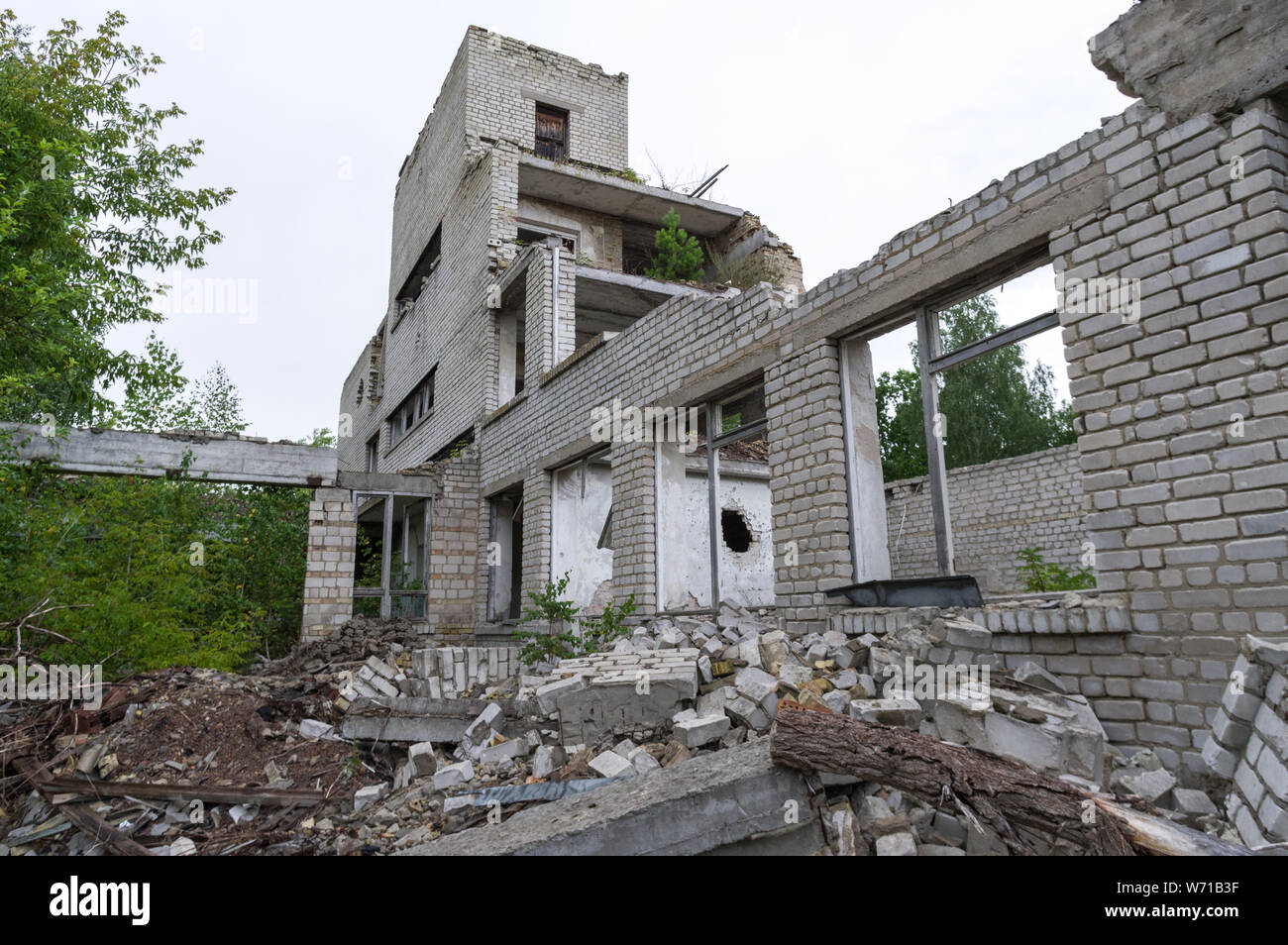 The ruin of an educational institution. The ruined school. White brick ...