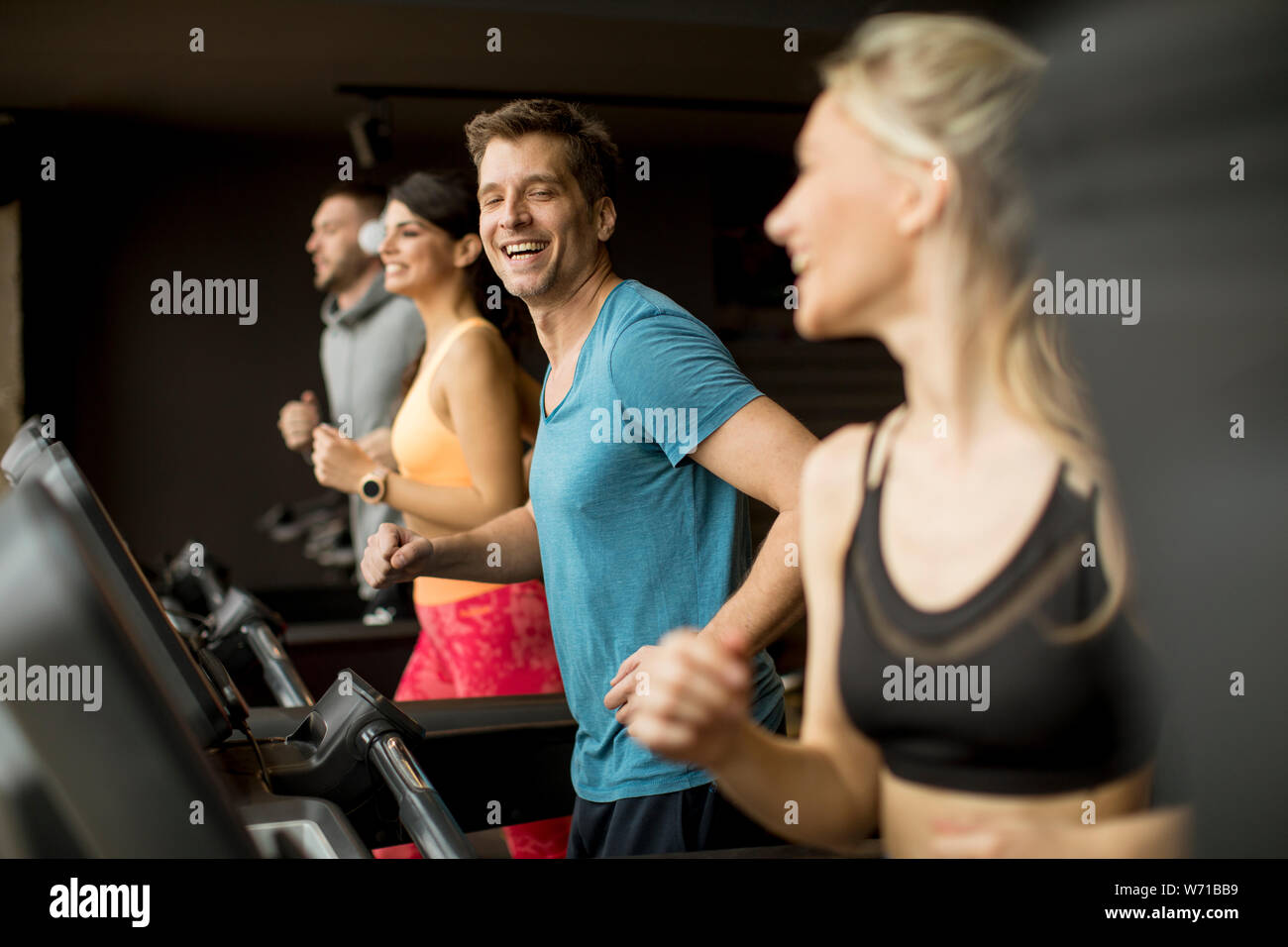 Group of young people using threadmill in modern gym Stock Photo - Alamy