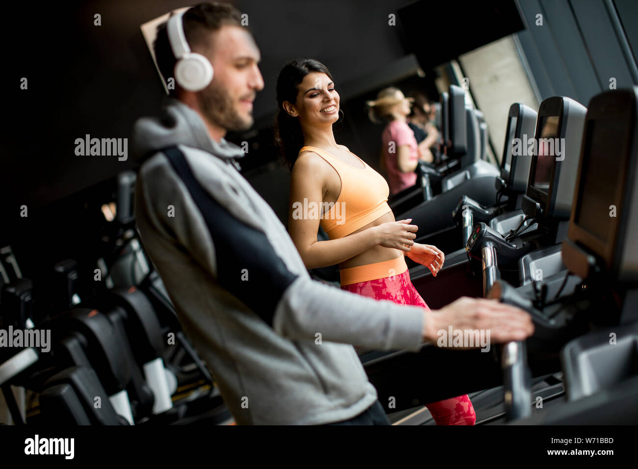 Group of young people using threadmill in modern gym Stock Photo - Alamy