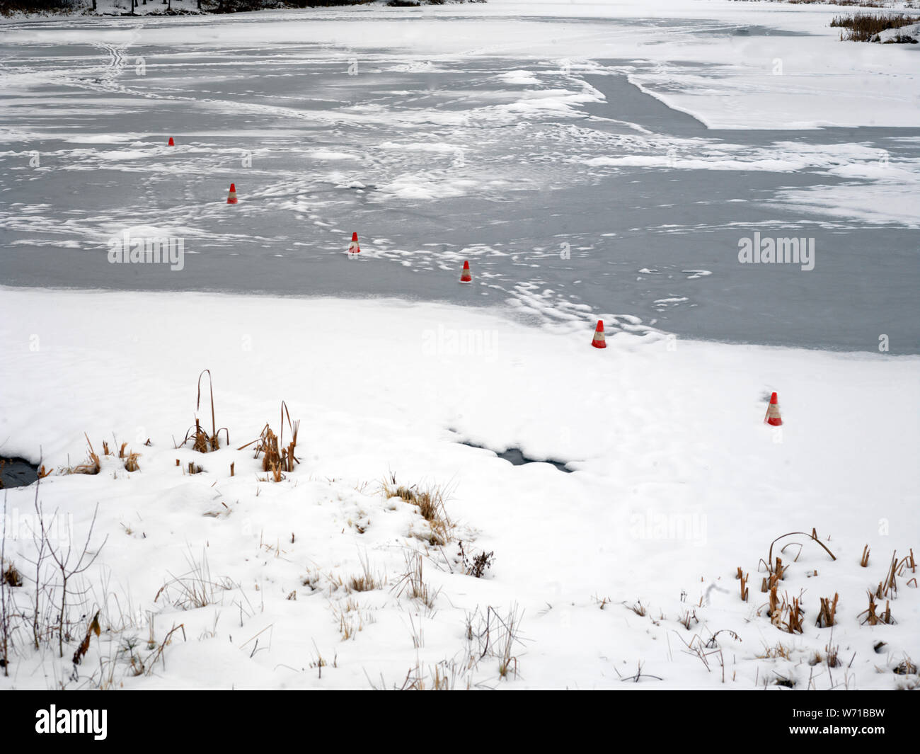 Safety cones on the frozen river for safe crossing, winter scene Stock ...