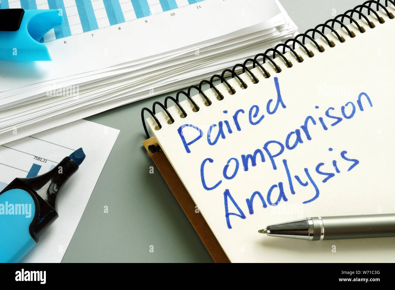 Paired comparison analysis report with stack of papers Stock Photo - Alamy