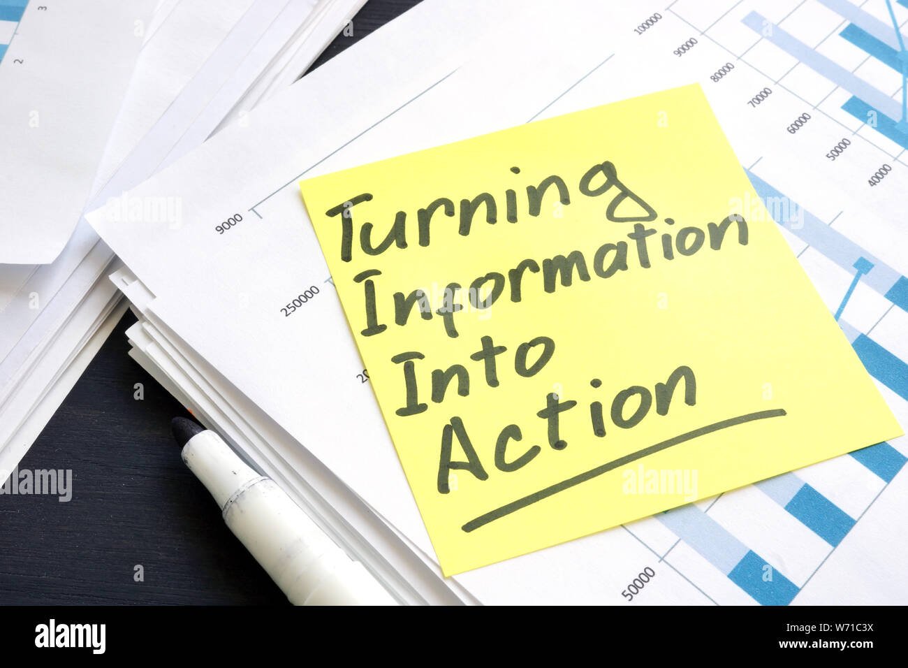 Turning information into action rule and stack of papers Stock Photo ...