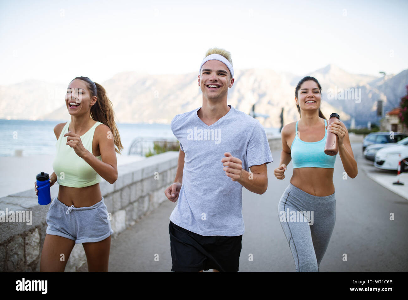 Group of young people friends running outdoors at seaside Stock Photo ...