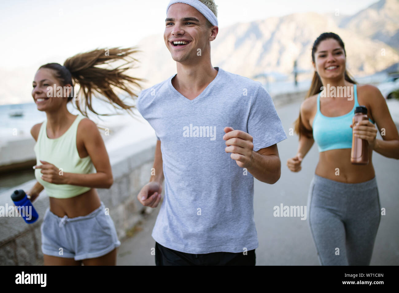 Group of young people friends running outdoors at seaside Stock Photo ...