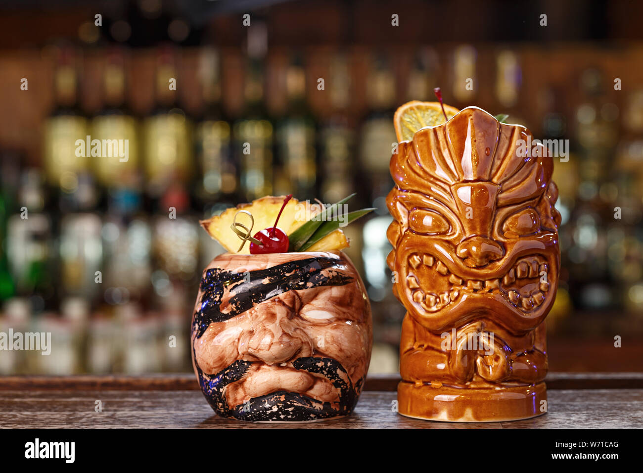 Refreshing alcoholic summer cocktails stand in a bar on a blurred ...