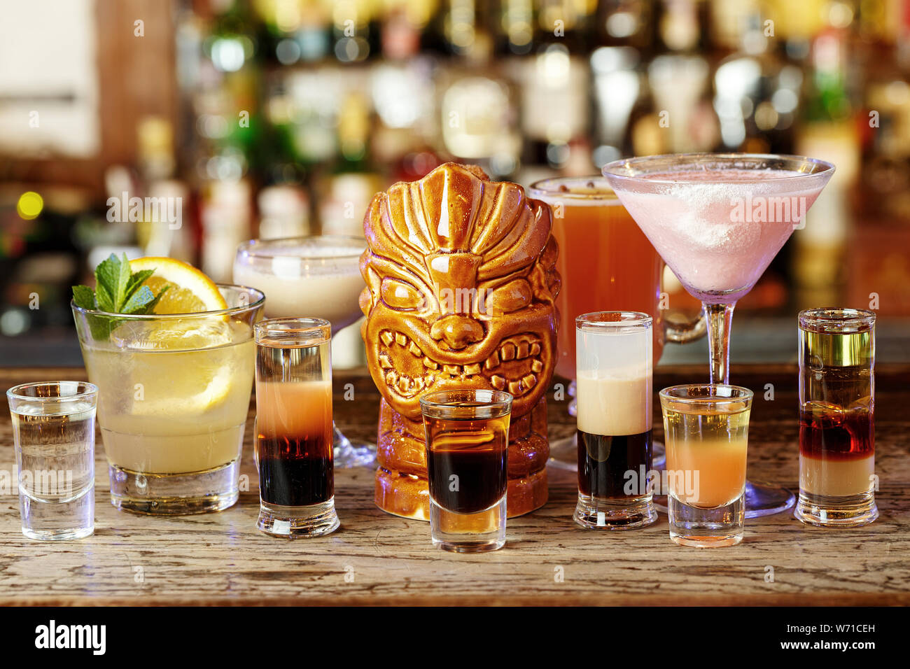mix of cocktails in a nightclub, stand in a row on a bar counter on a ...