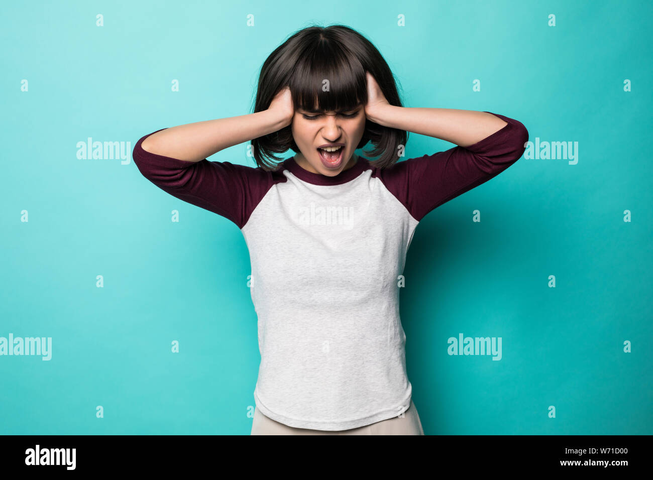 Screaming, hate, rage. Crying emotional angry woman screaming on blue ...