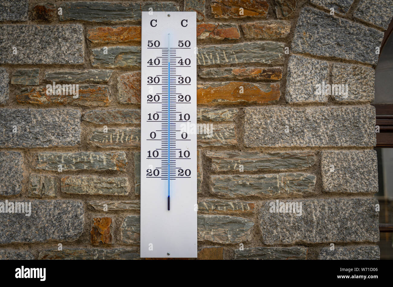 Thermometer showing more than 40 degrees celsius on a stone wall ...
