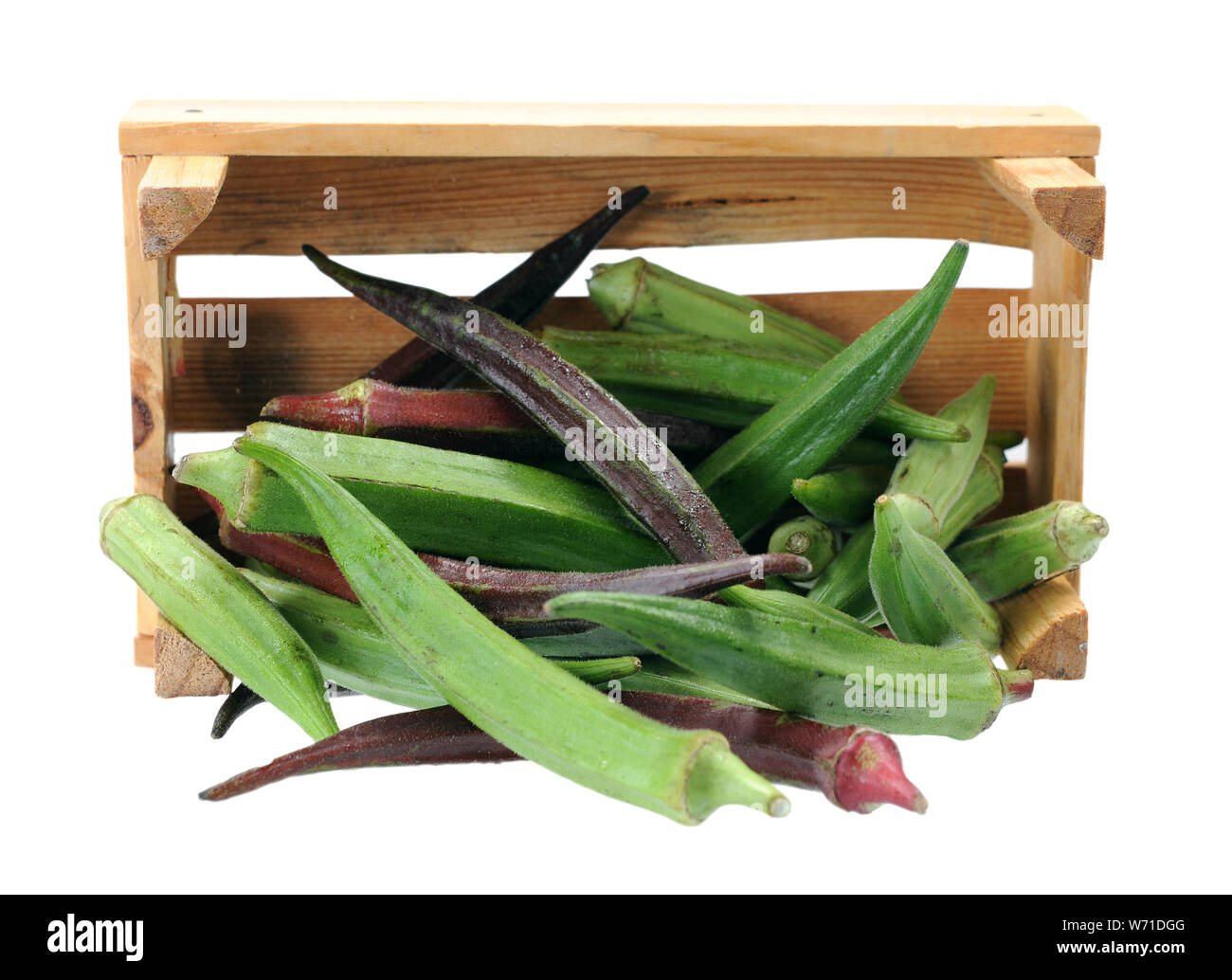 green and red okra falling out of crate Stock Photo - Alamy