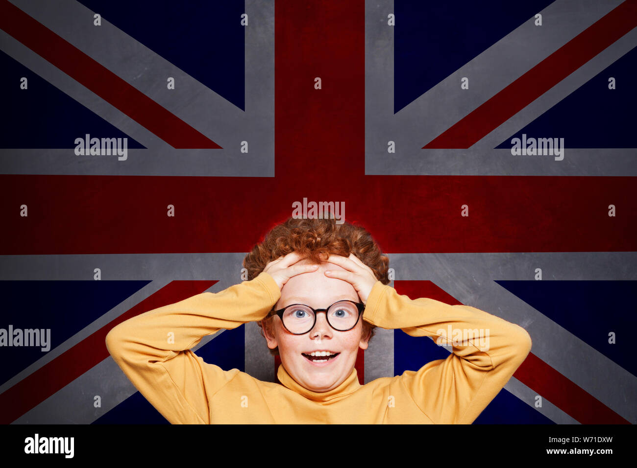 Happy surprised kid with the UK flag background. Learn English language ...
