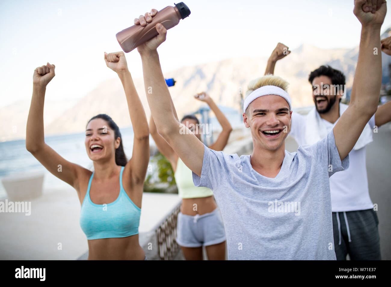 Outdoor portrait of group of friends running and jogging in nature ...