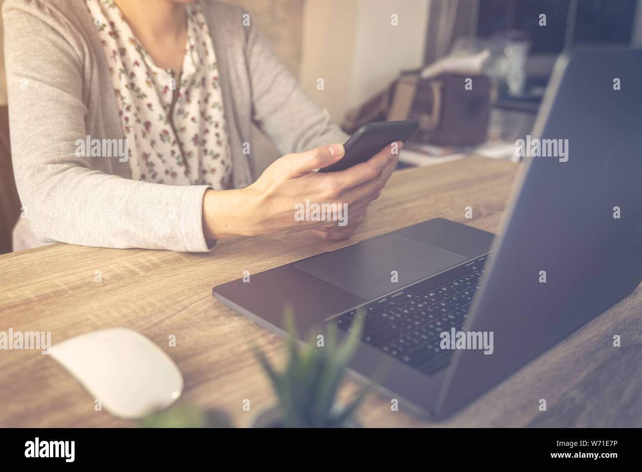 Business woman using laptop computer do online activity and holding ...