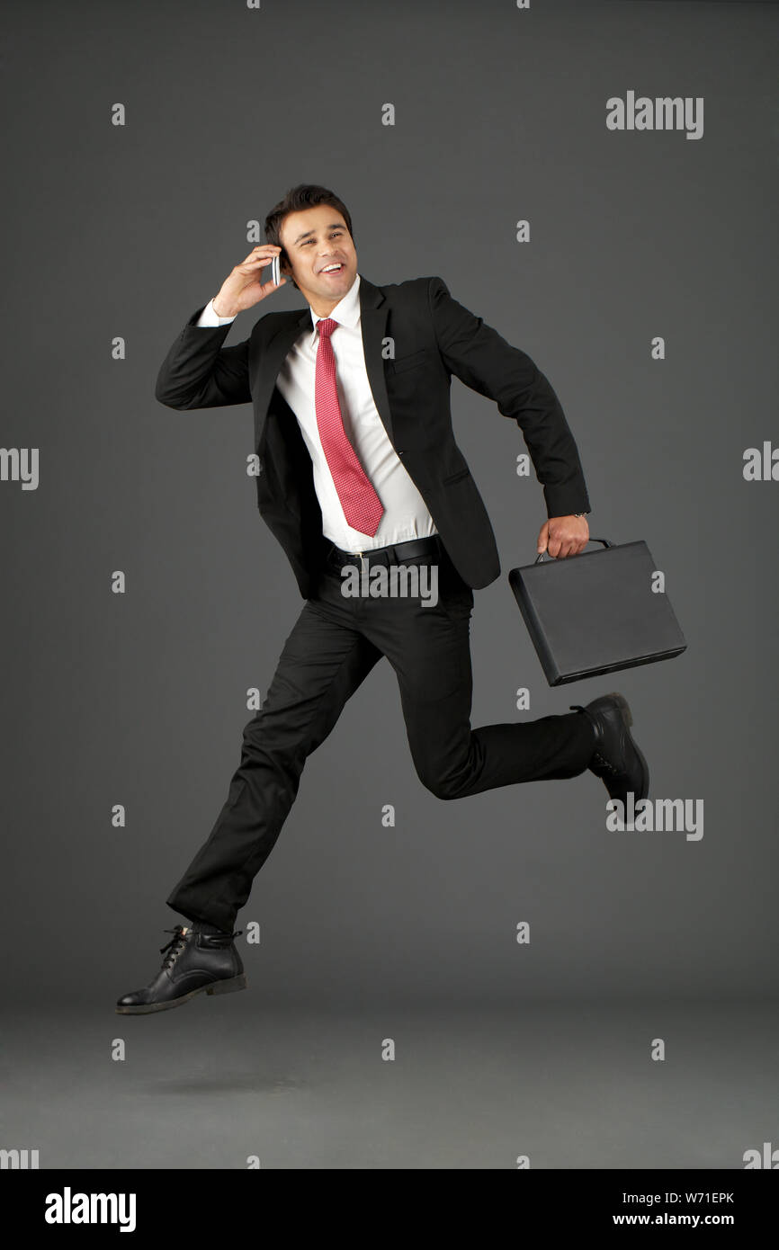 Man mobile phone jumping joy hi-res stock photography and images - Alamy