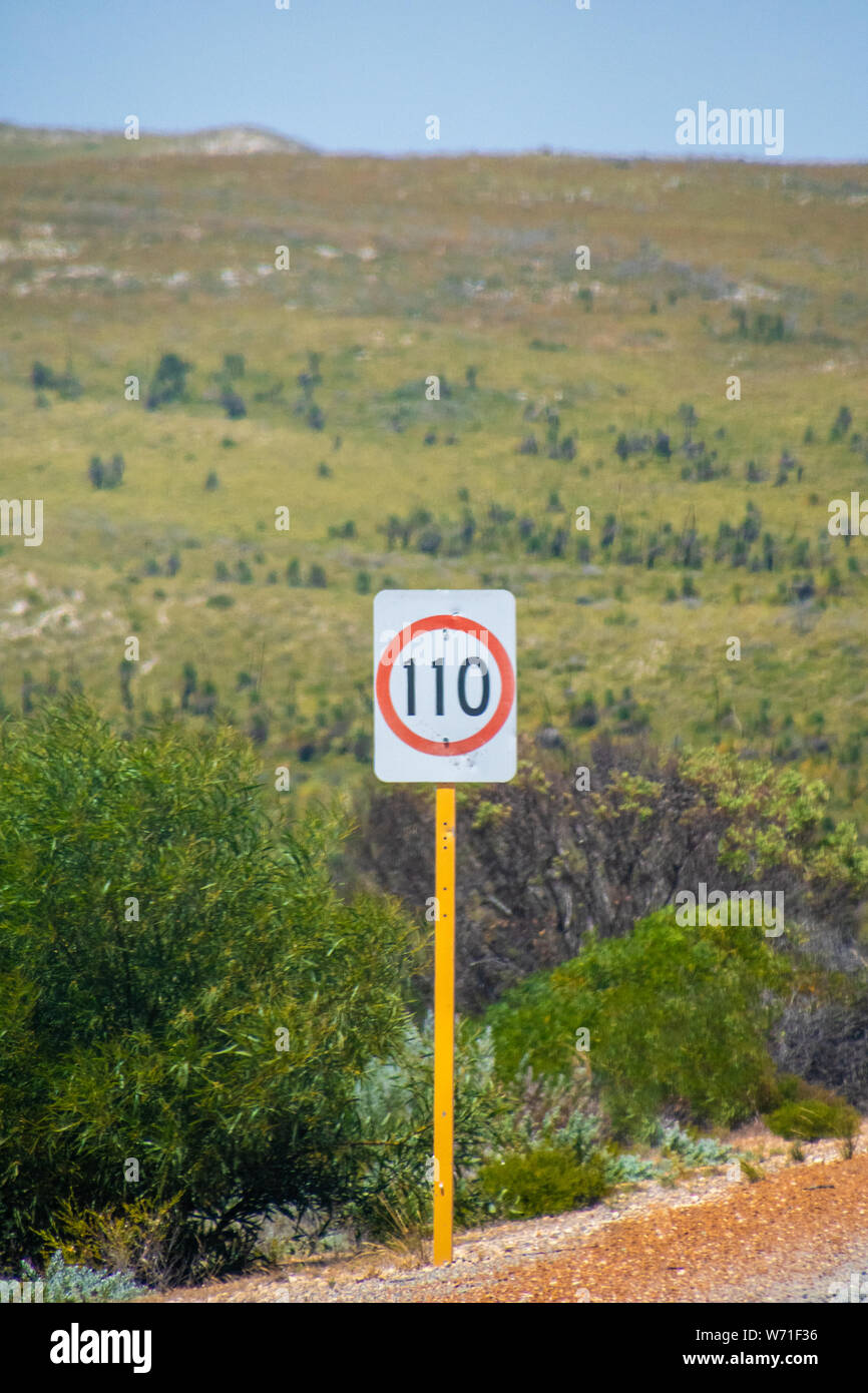 Speed limit 110 kph street sign next to an Australian road Stock Photo ...