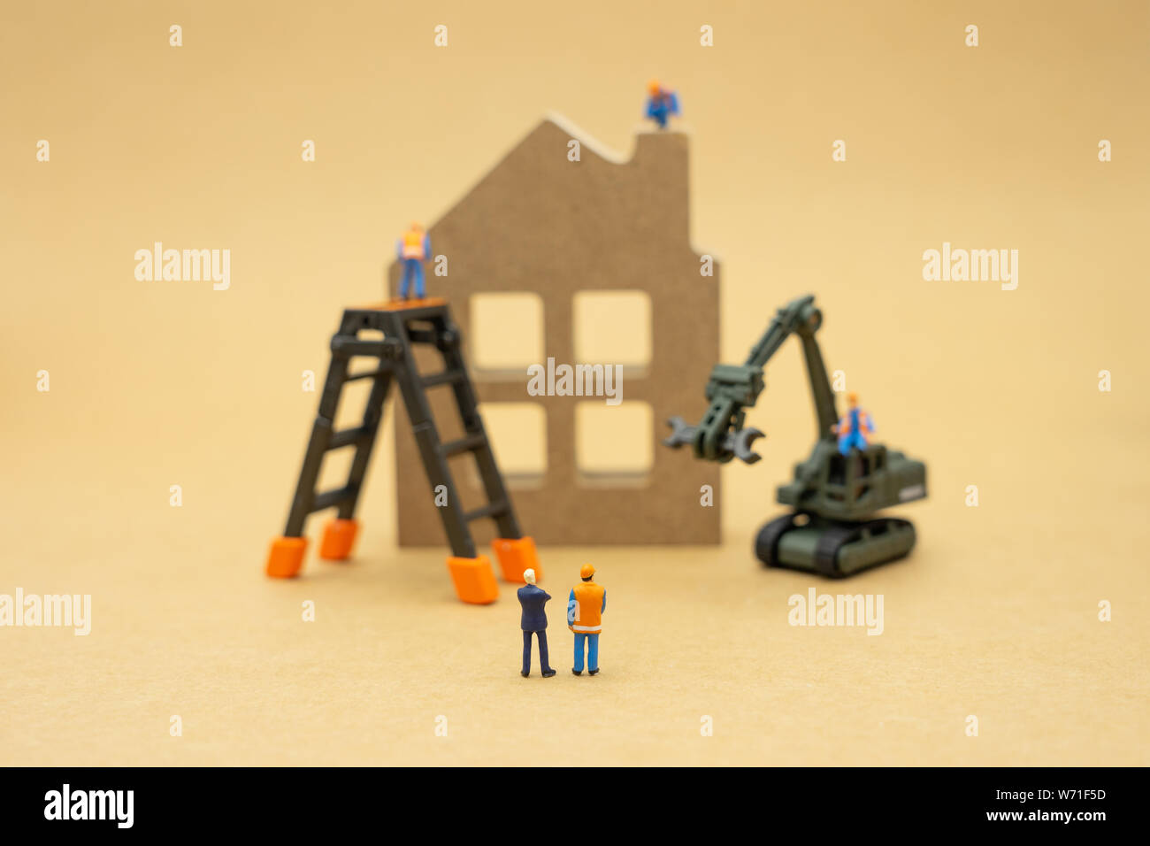 Miniature people Construction worker repair A model house model using ...