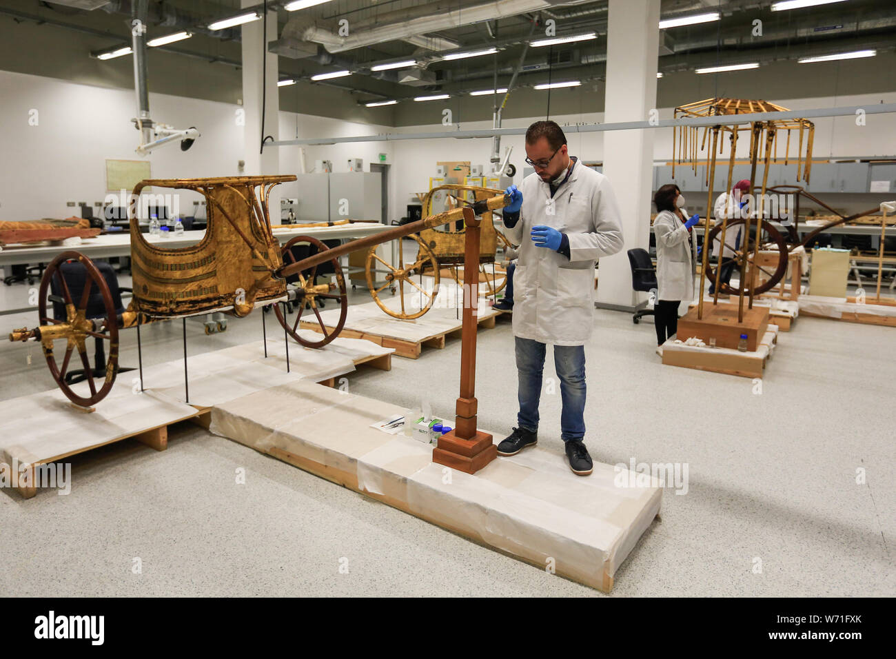 Giza, Egypt. 04th Aug, 2019. An Egyptian archaeologist works on the ...