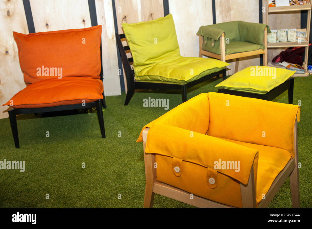 collection of colorful seats on decorative green floor Stock Photo - Alamy