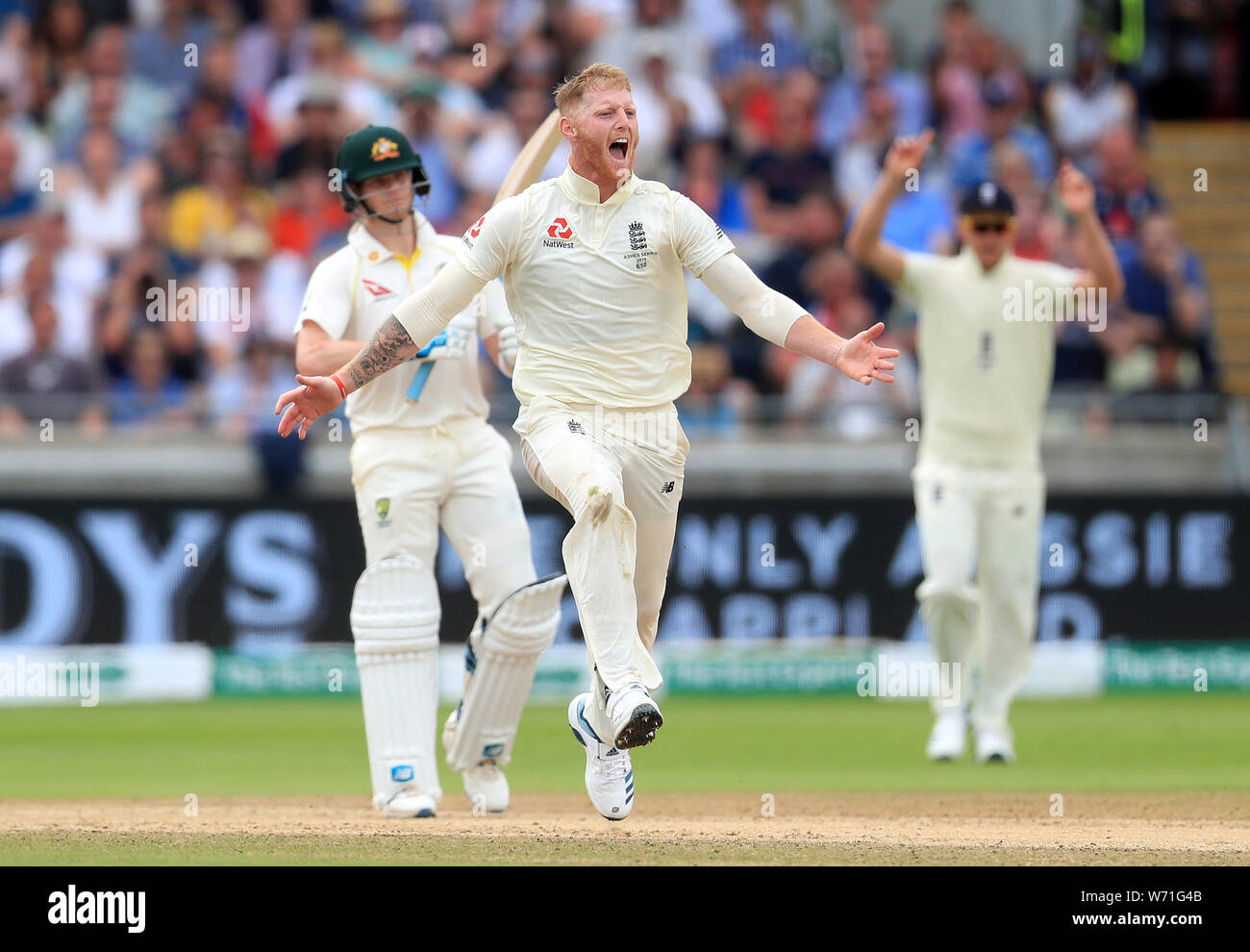 England's Ben Stokes celebrates taking the wicket of Australia's Travis ...