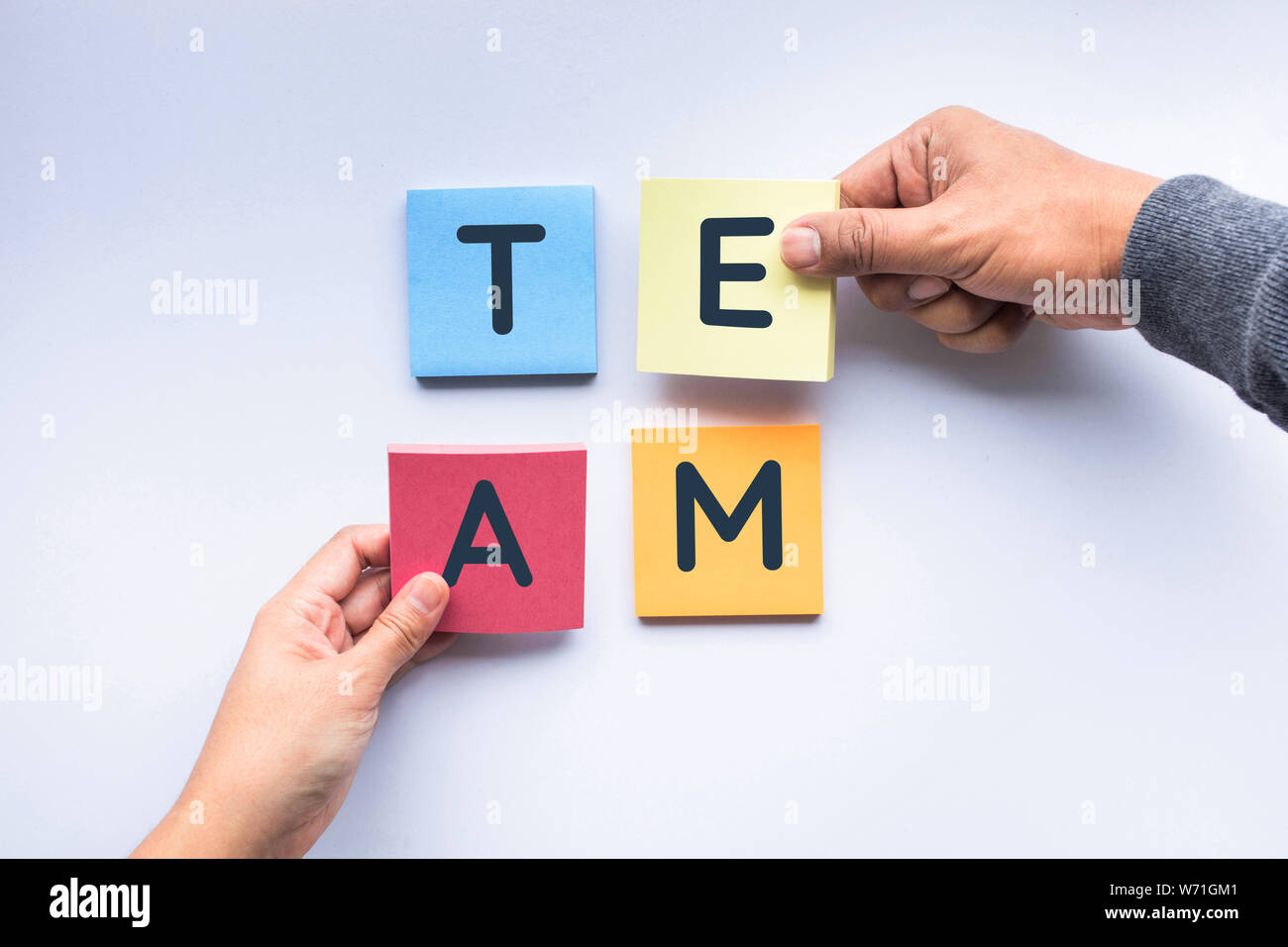 Team text on colorful notepaper with human hand.business concepts idea ...