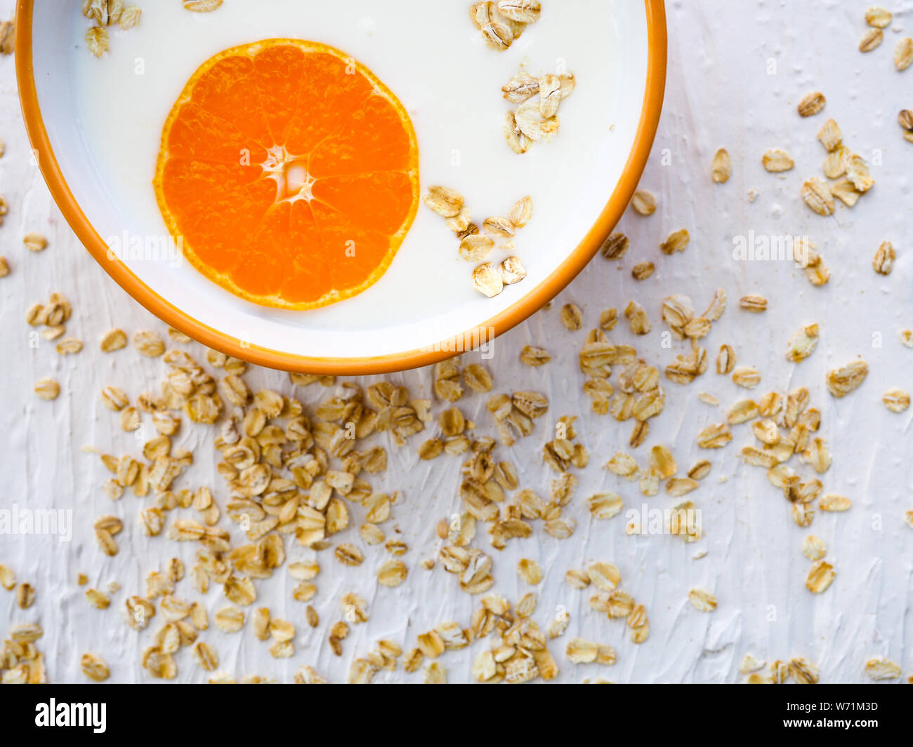 Oatmeal porridge on milk with Mandarin and kiwi Stock Photo - Alamy