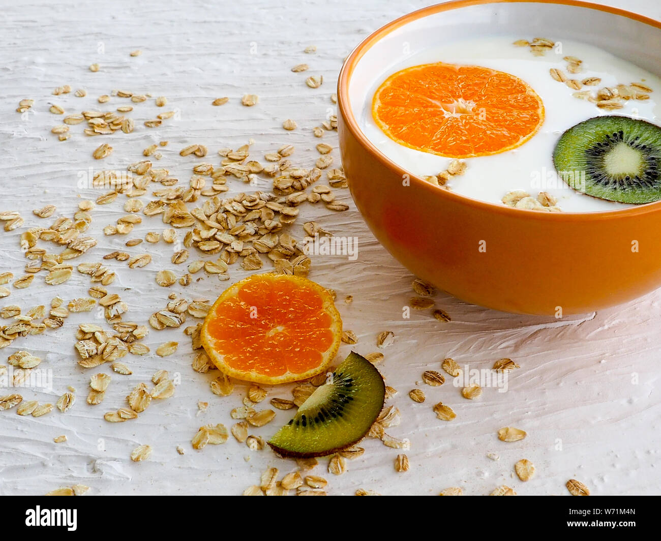 Oatmeal porridge on milk with Mandarin and kiwi Stock Photo - Alamy