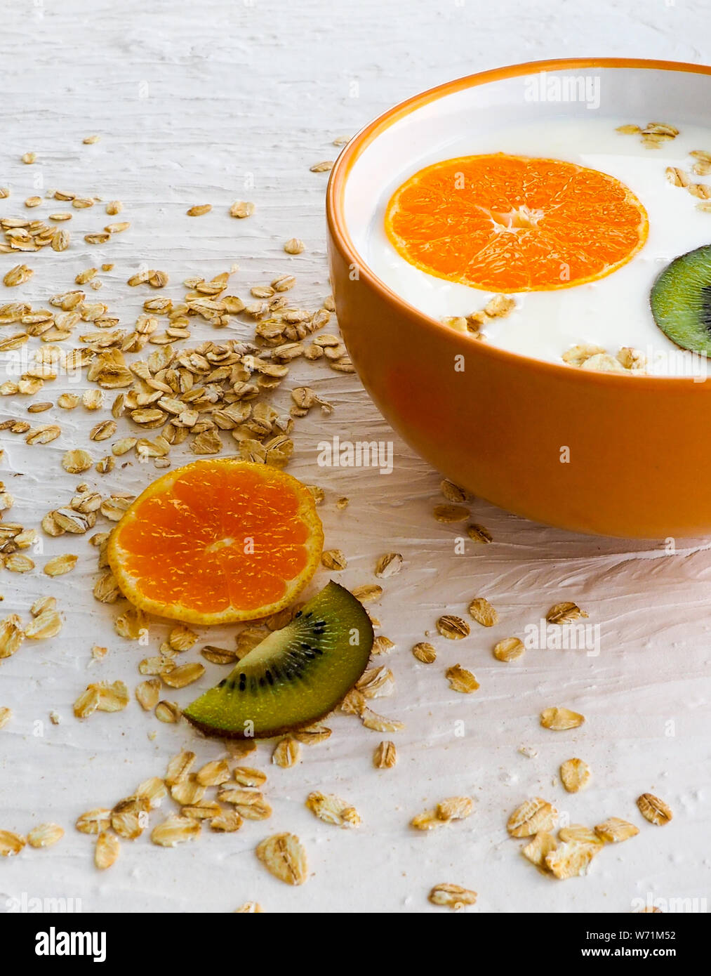 Oatmeal porridge on milk with Mandarin and kiwi Stock Photo - Alamy