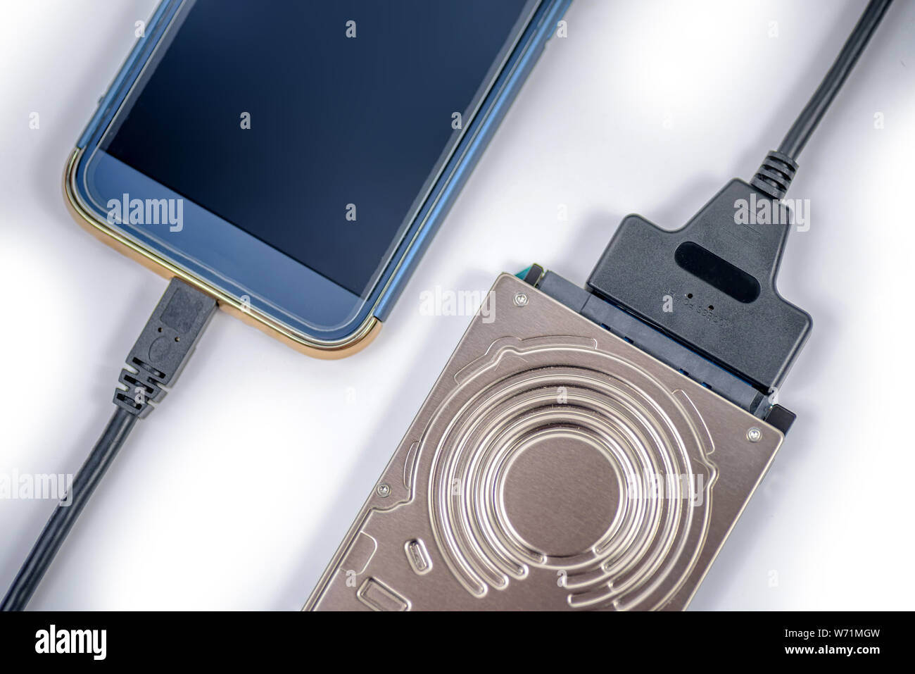 hdd 2.5 hard drive disk connected to smartphone via sata usb cable ...