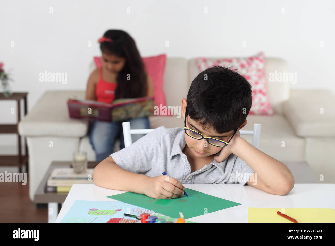 Boy drawing on a sheet of paper Stock Photo - Alamy