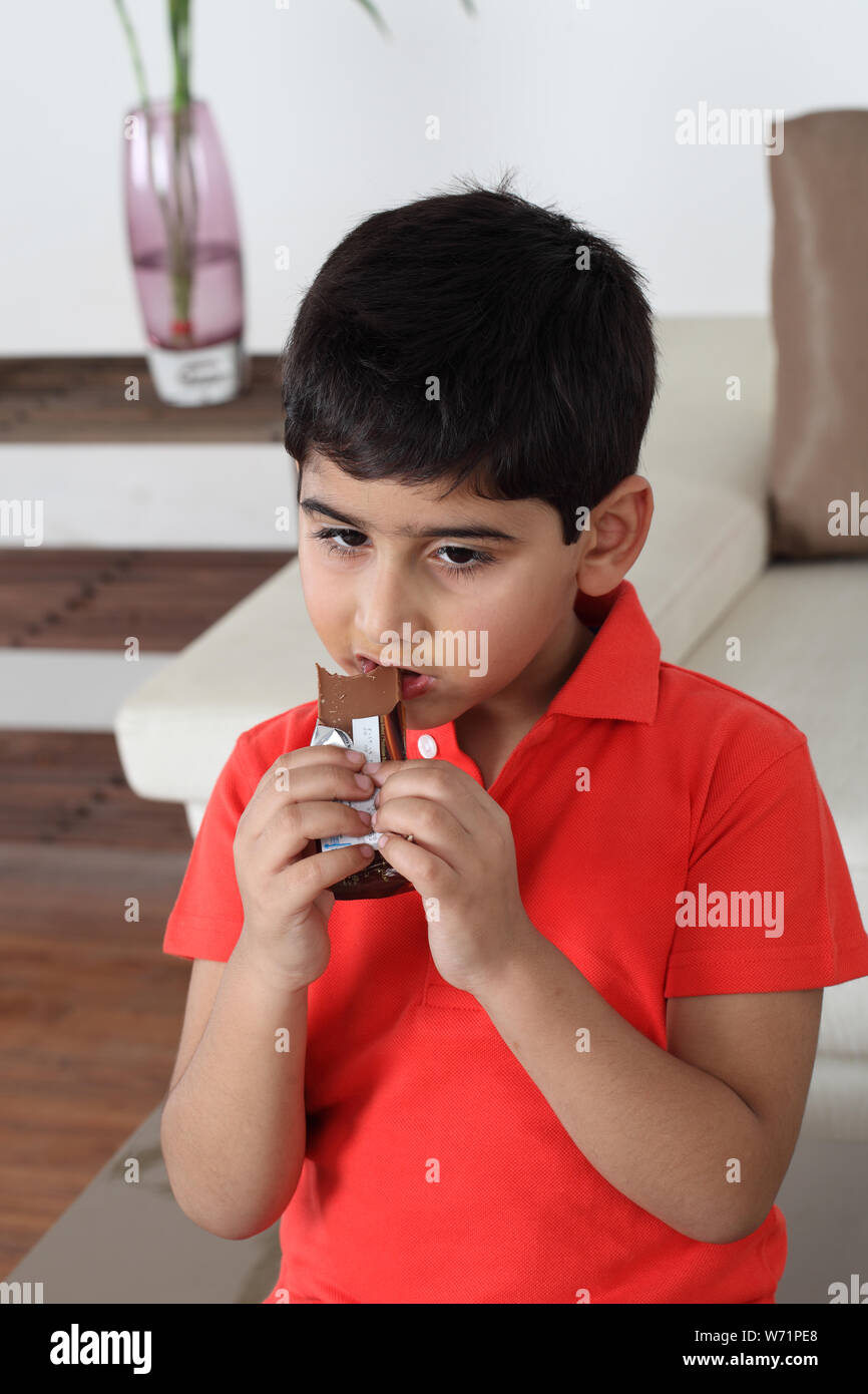 Child eating bar of chocolate hi-res stock photography and images - Alamy