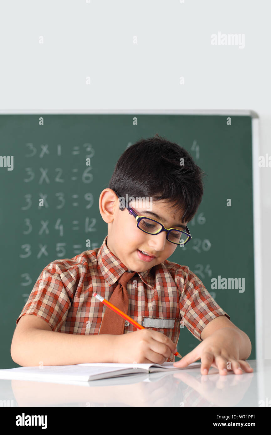 Schoolboy studying in a classroom Stock Photo - Alamy