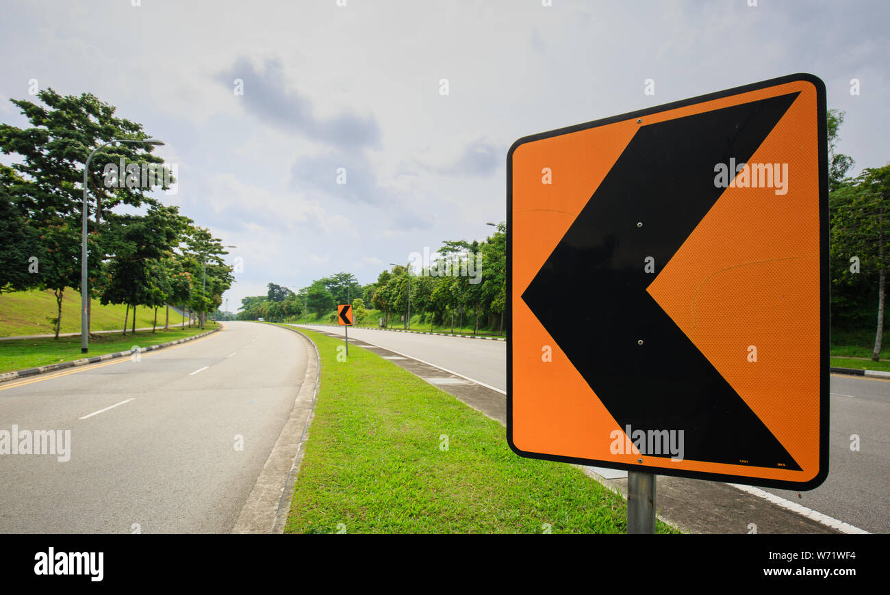 Traffic sign turn left curve and road in the forest.Landscape natural ...