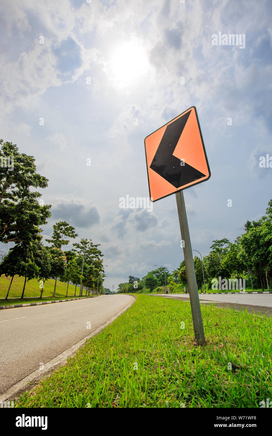 Traffic sign turn left curve and road in the forest.Landscape natural ...