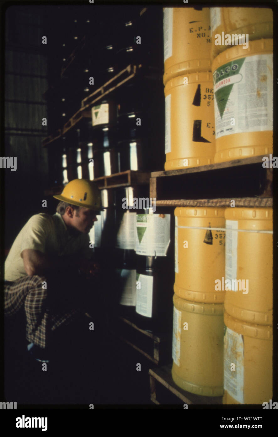 AN ENVIRONMENTAL PROTECTION AGENCY INSPECTOR CHECKS A LABEL ON A ...
