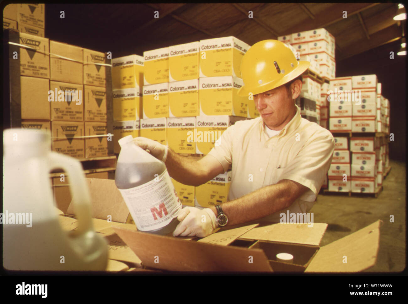 AN ENVIRONMENTAL PROTECTION AGENCY INSPECTOR EXAMINES A CONTAINER OF ...