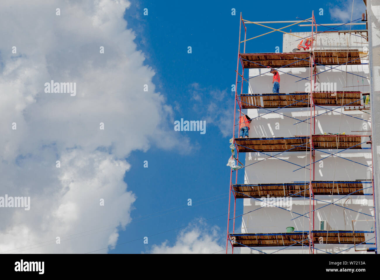 Scaffolding on a multistory building. Warming of the outer wall panel ...