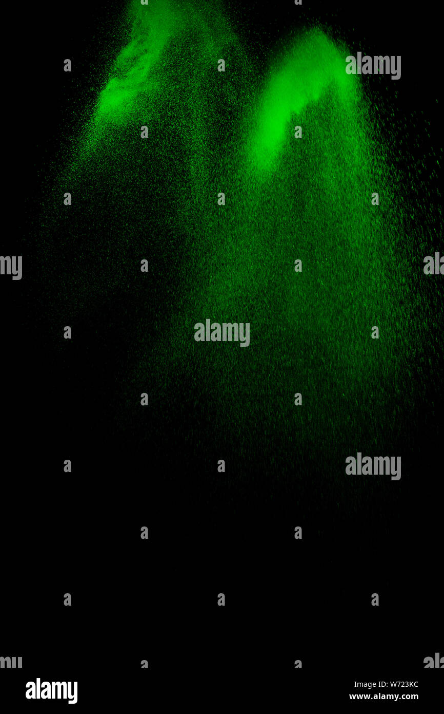 Green particles explosion on black background. Color dust splash use ...