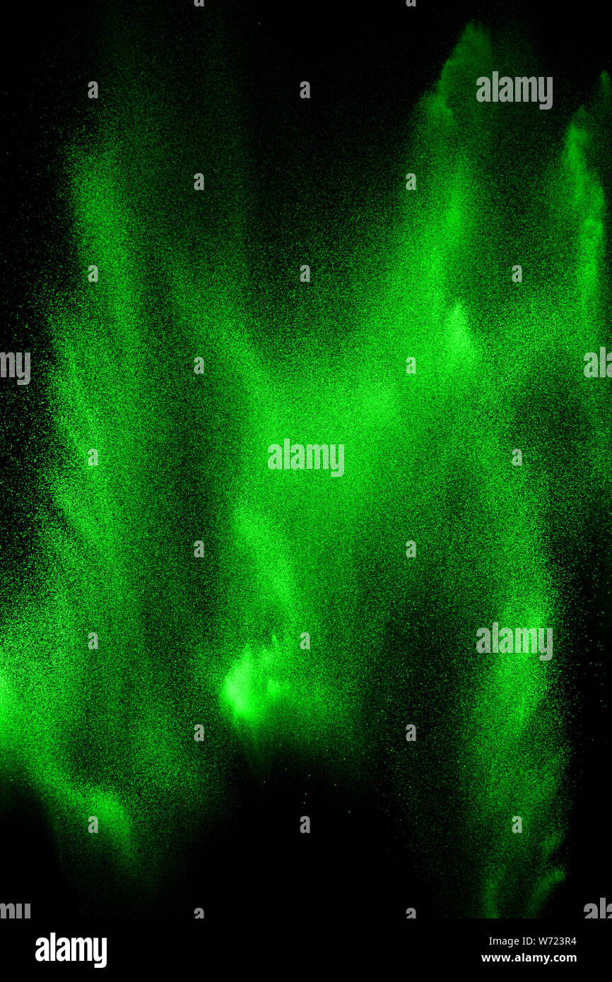 Green particles explosion on black background. Color dust splash use ...