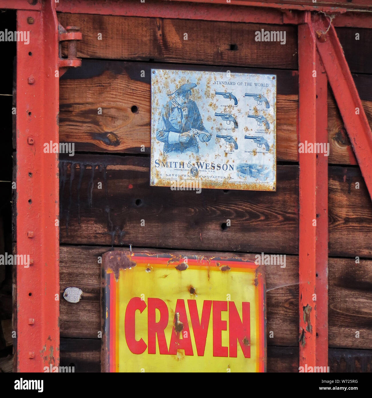 Enameled metal advertising boards or signs from a bygone era with ...