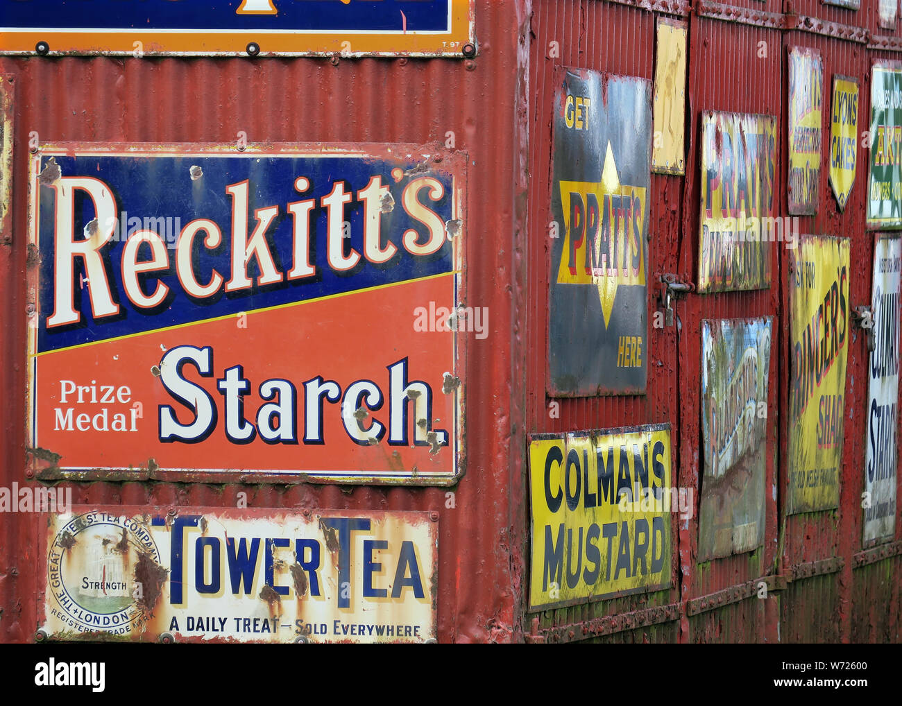 Enameled metal advertising boards or signs from a bygone era with ...