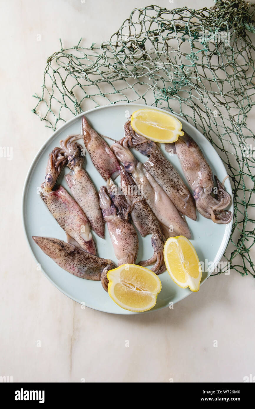 Raw squids calamari Stock Photo - Alamy