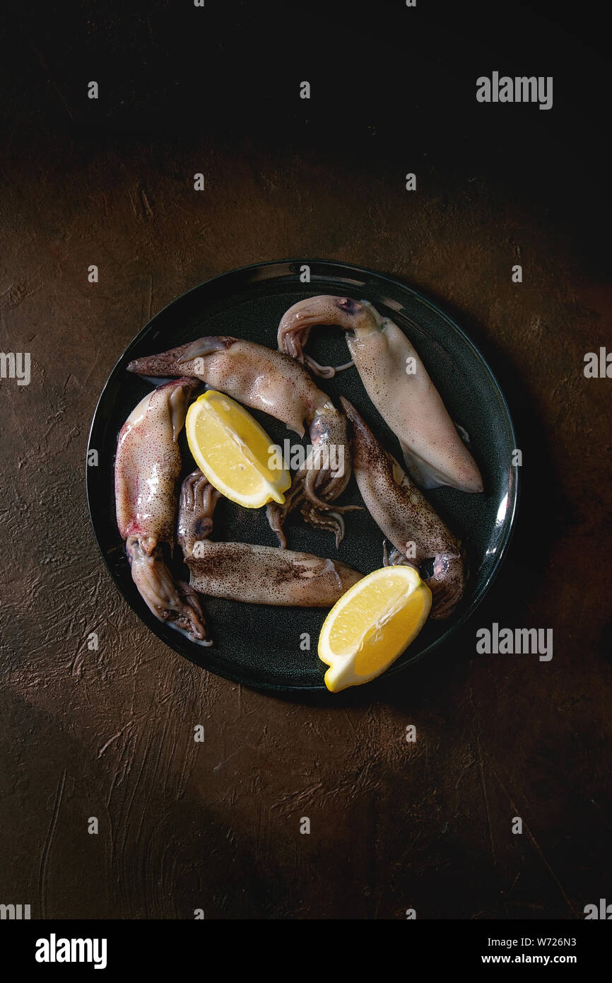 Raw squids calamari Stock Photo - Alamy