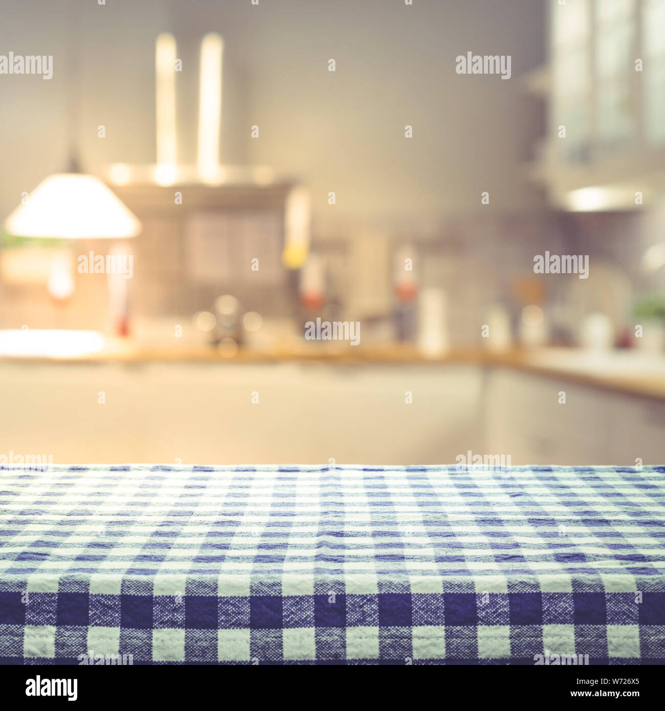 Checkered tablecloth texture top view with blur kitchen room background ...