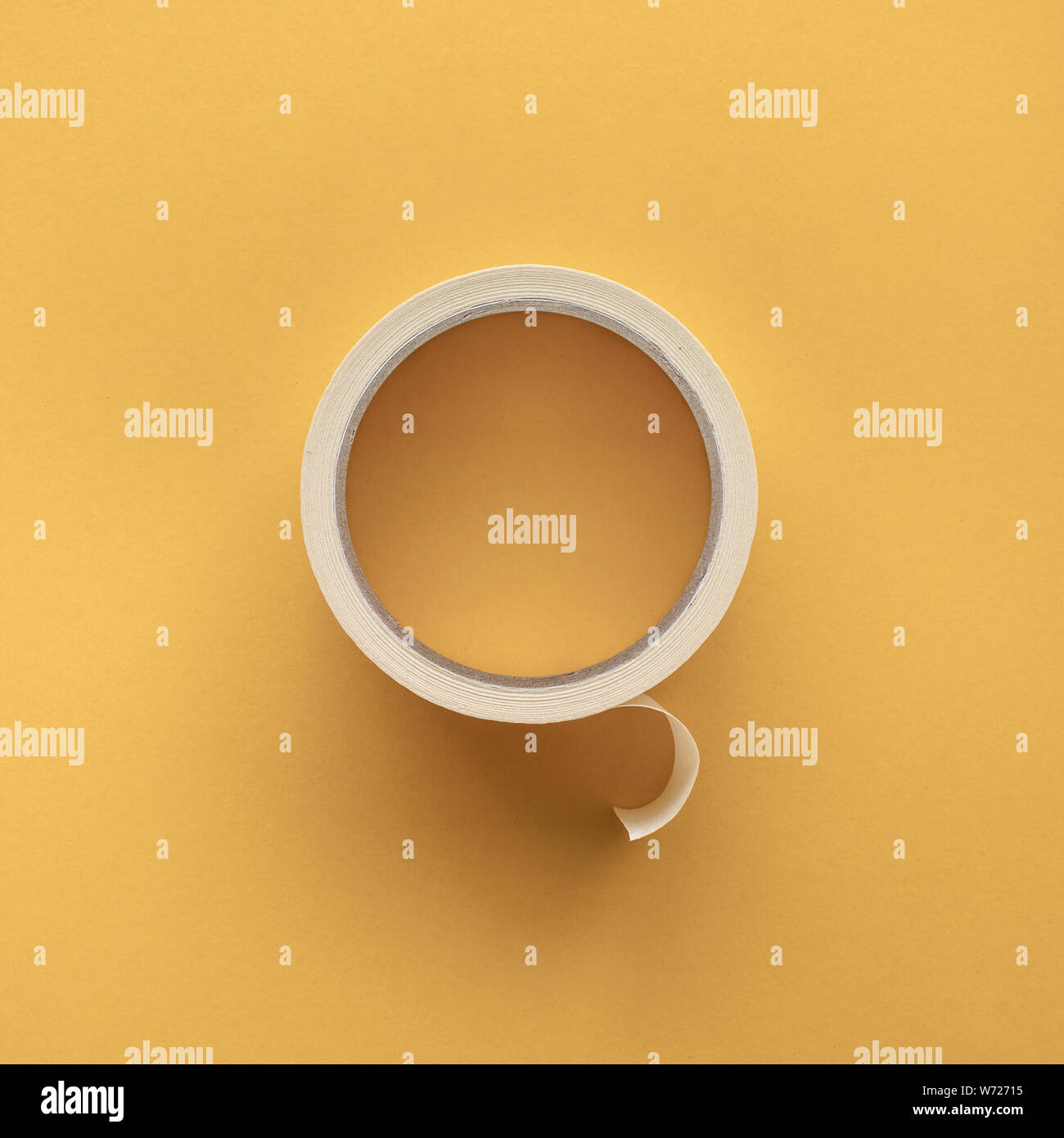Sticky tape roll in yellow color background Stock Photo - Alamy