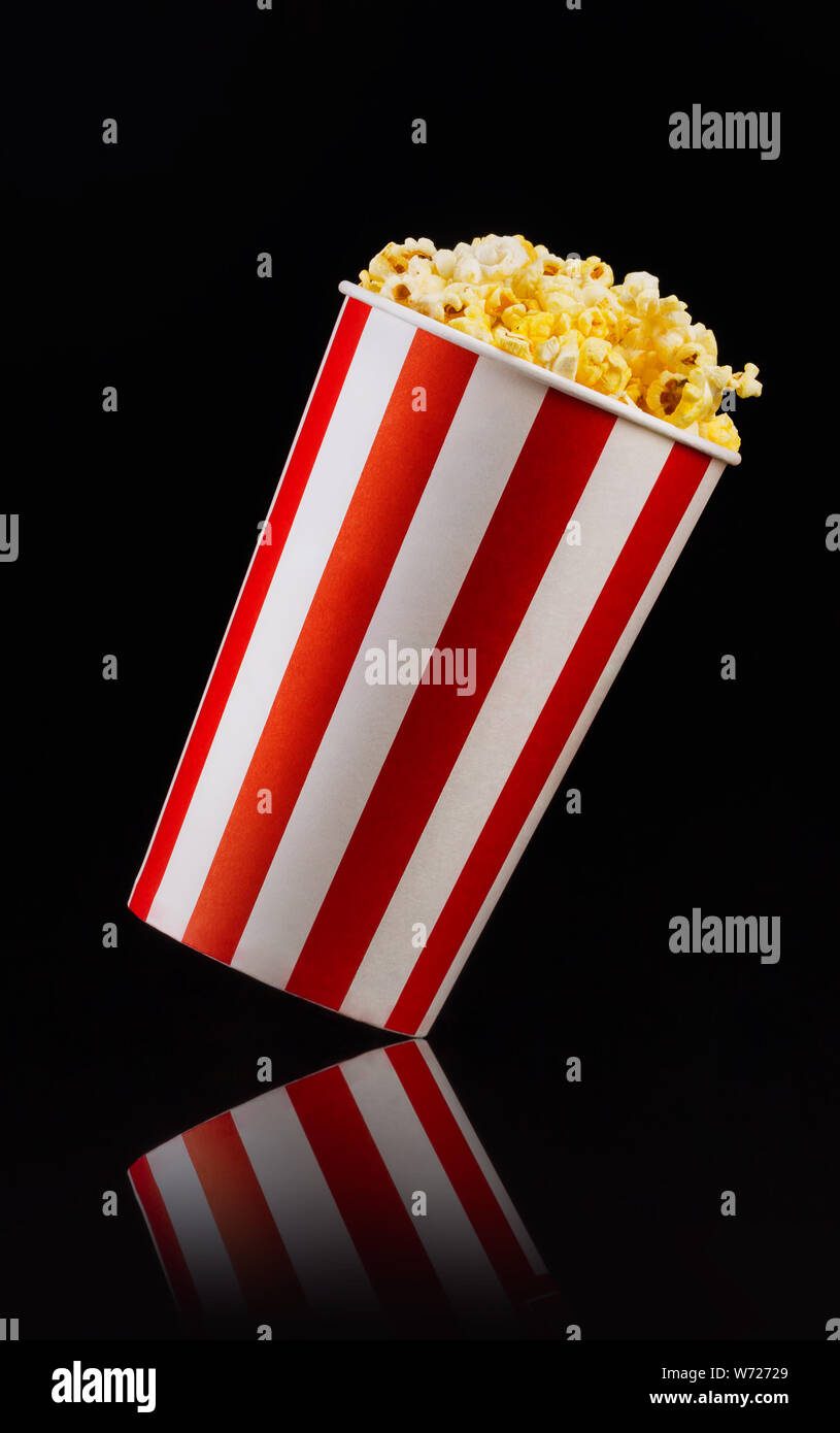 Paper striped bucket with popcorn isolated on black background Stock ...