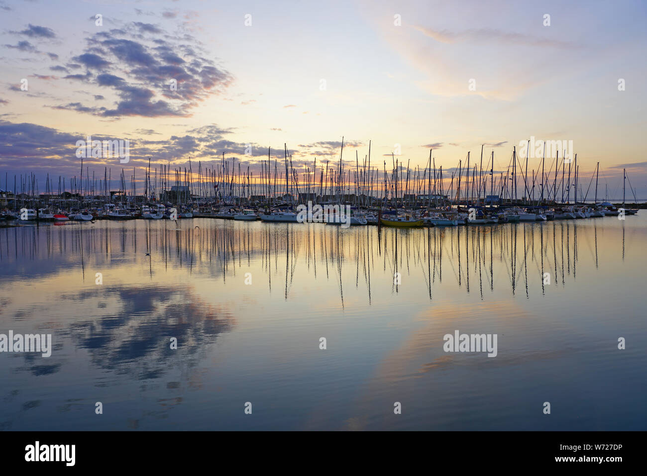 HOWTH, IRELAND- 27 JUL 2019- Colorful sunset sky over boats in Howth, a ...